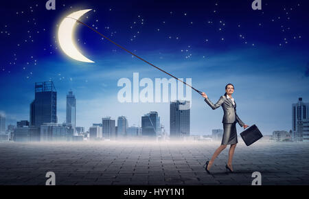 Woman catch moon Stock Photo - Alamy