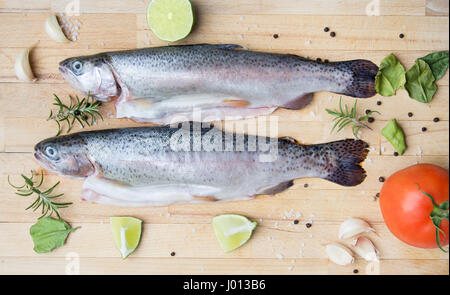 Rainbow trouts on a wooden table. Selective focus Stock Photo - Alamy