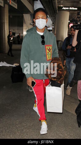 Pharrell Williams wears a surgical face mask as he arrives at Los ...