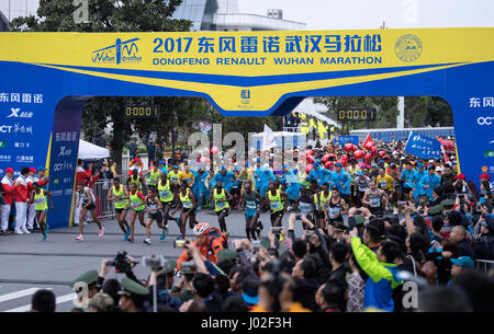 Wuhan. 9th Apr, 2017. Runners run on the Yangtze River Bridge during ...
