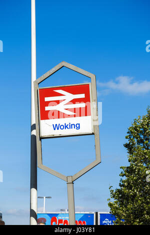 Crooked, leaning railway sign at Woking station, Woking, Surrey, south ...