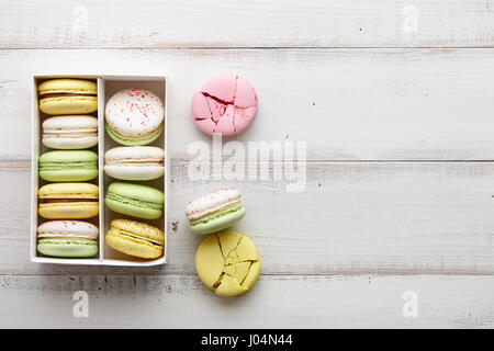 Macaron dessert, a box with colorful macarons lies on a marble style ...