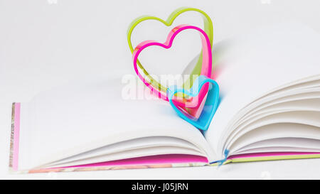 Red and blue hearts over diary book on white table Stock Photo - Alamy