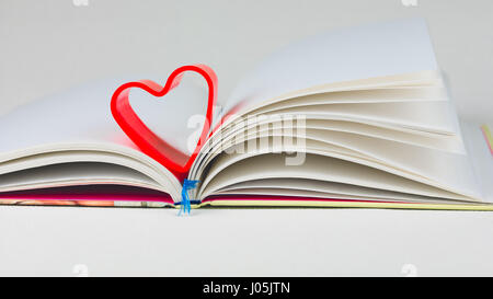 Red heart over diary book with bookmark on white table Stock Photo - Alamy