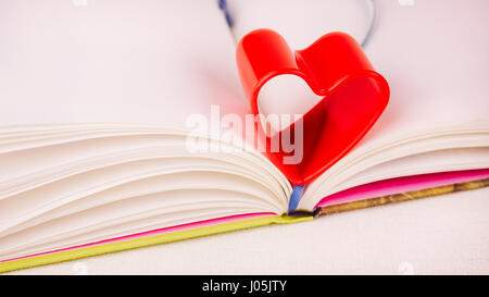 Red heart over diary book on white table Stock Photo - Alamy