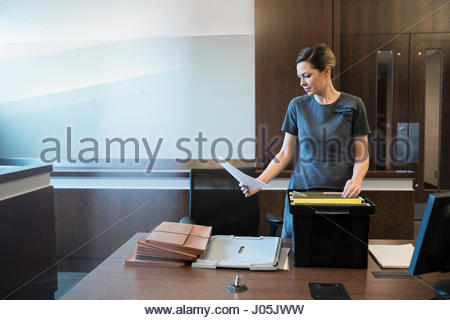 Female prosecutor attorney reviewing paperwork in courtroom Stock Photo ...