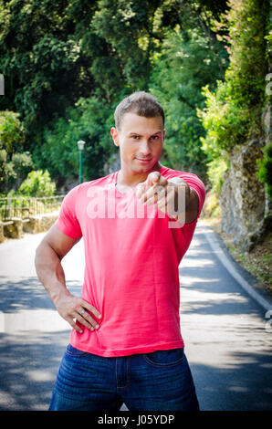 Young handsome man pointing fingers to camera with happy and funny face ...