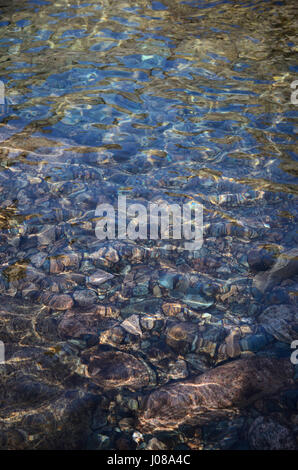Stream water flowing through stones Stock Photo - Alamy