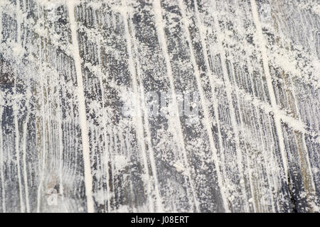 White flour scattered on rustic wooden table with baking background and ...