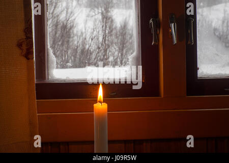 candle in the window of Norwegian cabin Stock Photo - Alamy