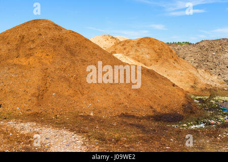 Piles of soil deposits at landfill over old dump Stock Photo - Alamy