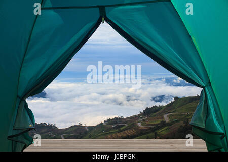 View from the tent, open tent with mountain views, trekking boots and ...