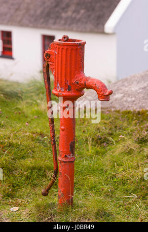 CRUIT ISLAND, DONEGAL, IRELAND - Old red water pump Stock Photo - Alamy