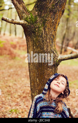 Young girl leaning against a tree in daffodil woods Stock Photo - Alamy