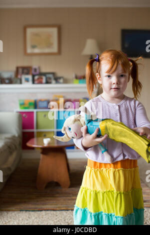 Portrait of a girl holding a rag doll Stock Photo - Alamy