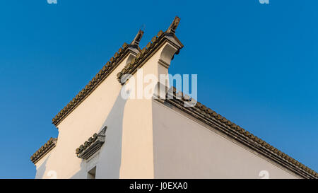 A Chinese Hui Style house with black roof tiles, white wall, and ...