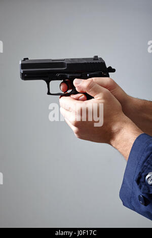 Closeup view of man's hands aiming with gun Stock Photo - Alamy