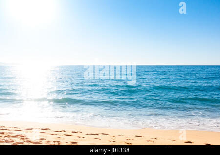 Sand coastline against bright shining sun Stock Photo - Alamy
