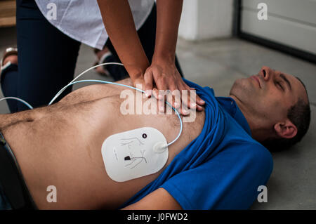 a girl helping a guy after heart attack with cardiopulmonary ...