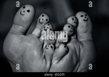 all ten toes of feet with smiley faces drawn with black pen Stock Photo ...