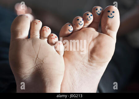 all ten toes of feet with smiley faces drawn with black pen Stock Photo ...