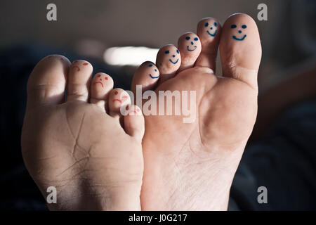 all ten toes of feet with smiley faces drawn with black pen Stock Photo ...