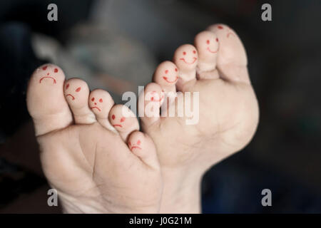 all ten toes of feet with smiley faces drawn with black pen Stock Photo ...