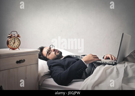 Tired businessman sleeping with laptop, wake up and start talking phone ...