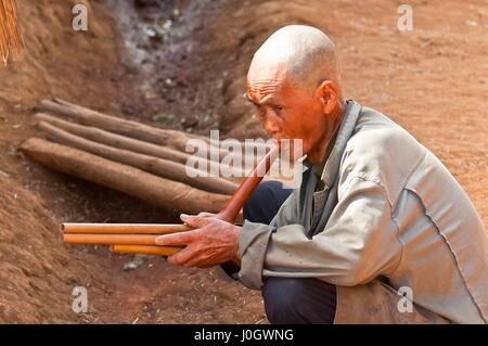 Portrait of Akha Man from northern Thai Hill Tribe Smoking Opium Pipe ...