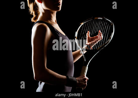 Midsection of young female caucasian player with racket and ball at ...
