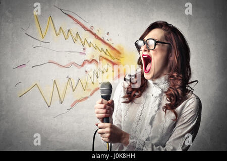 Woman yelling into microphone Stock Photo - Alamy