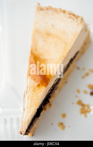 Bright yellow creamy cheese sauce in elegant white triangular bowl on ...