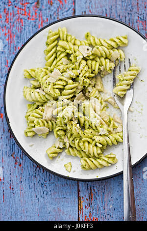 Penne pasta with pesto sauce and basil on wooden table Stock Photo - Alamy