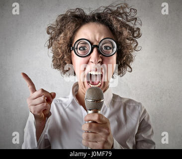 Woman yelling into microphone Stock Photo - Alamy