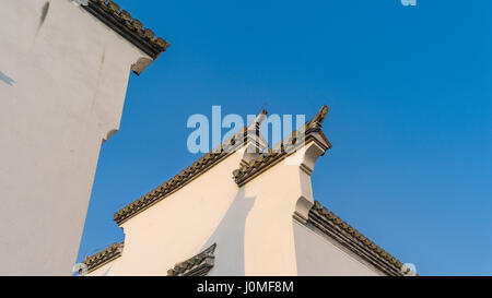 A Chinese Hui Style house with black roof tiles, white wall, and ...