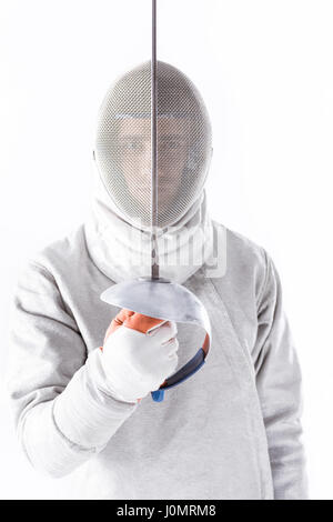 portrait of fencer in uniform holding rapier in hand on white Stock ...