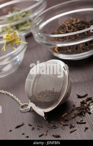 Bowls with dry tea leaves on dark table Stock Photo - Alamy