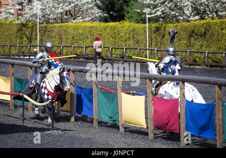 Men dressed as knights takes part in a jousting competition during the ...