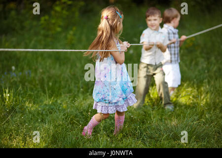 children pulling the rope outdoors Stock Photo - Alamy