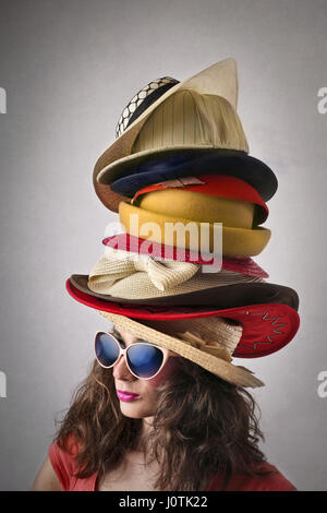 Woman wearing many hats Stock Photo - Alamy
