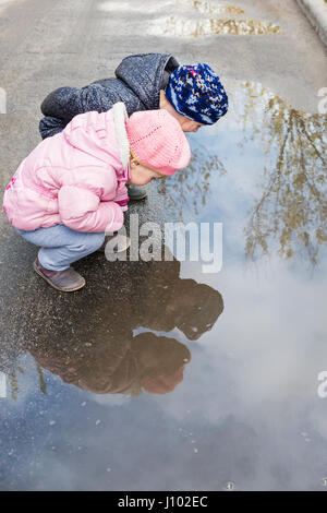 Little girl looking into puddle, children, unforgettable moments, fun ...