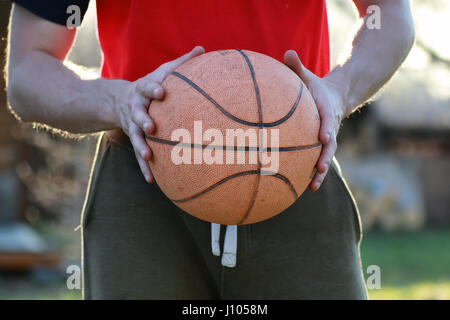 basketball hold by one hand Stock Photo - Alamy