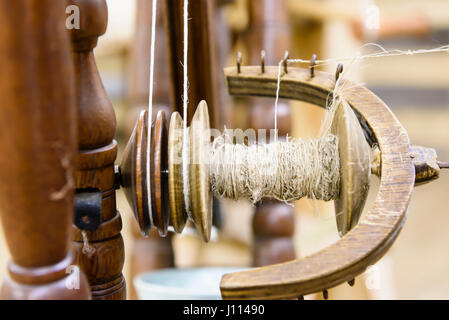 Linen thread being spun and wound onto a bobbin at the Wellbrook ...