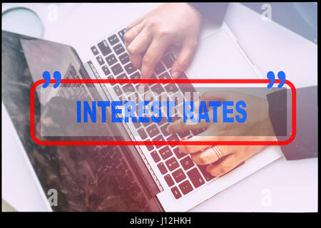 Hand and text "INTEREST RATES" with vintage background. Technology ...