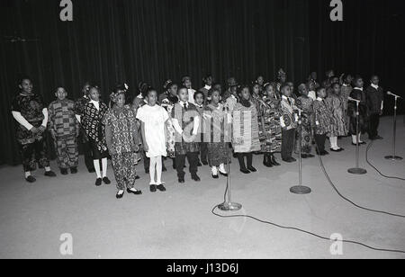 Children stand and sing during a school or community event ...