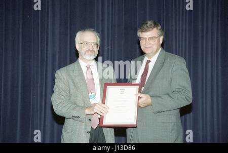 An individual receives an award during a formal honors ceremony at ...