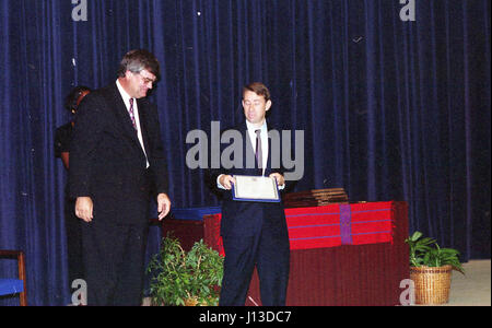 Individual stands on stage to receive an award during a Combined ...