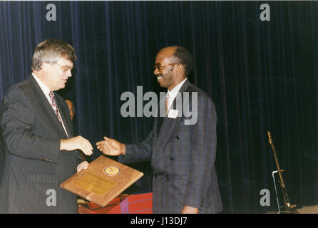 An individual receives an award during a USAID honors ceremony ...
