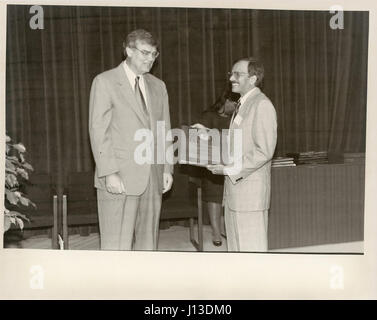 An individual receives an award during a formal honors ceremony at ...