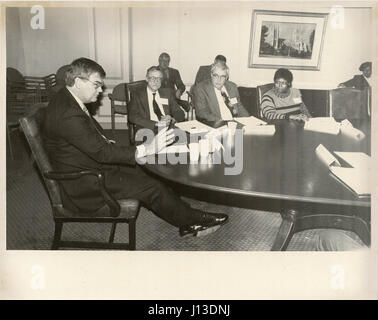 Male and female military personnel engage in discussion, exchanging ...